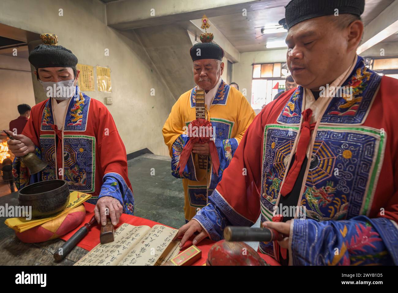 A traditional shaman performing a ritual with offerings to the ...