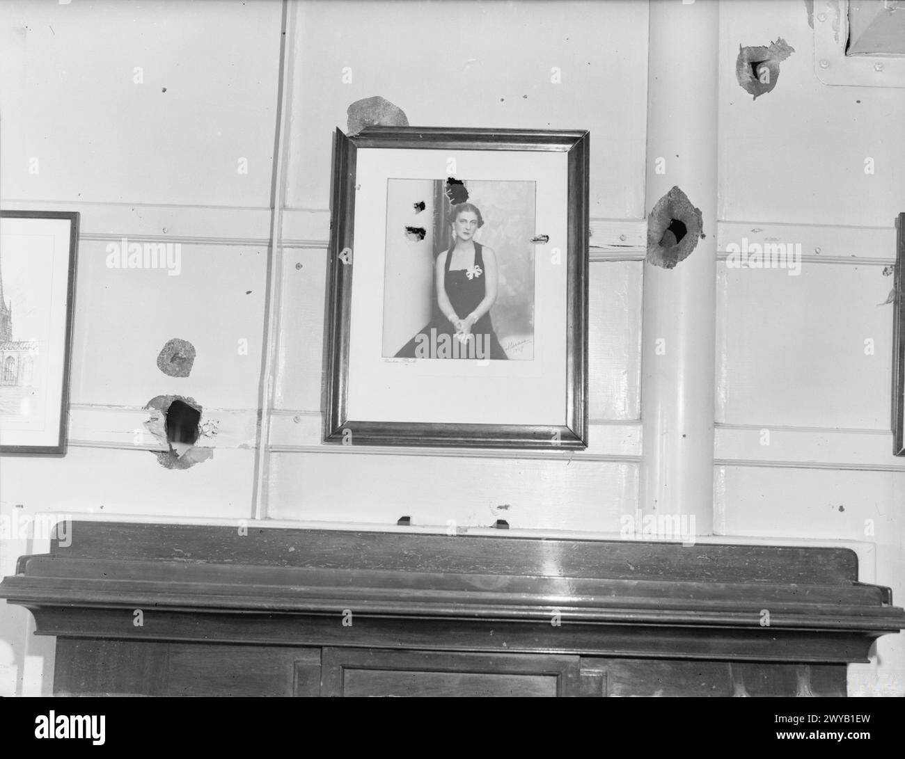 Splinter holes are visible in and around the portrait of HRH The ...