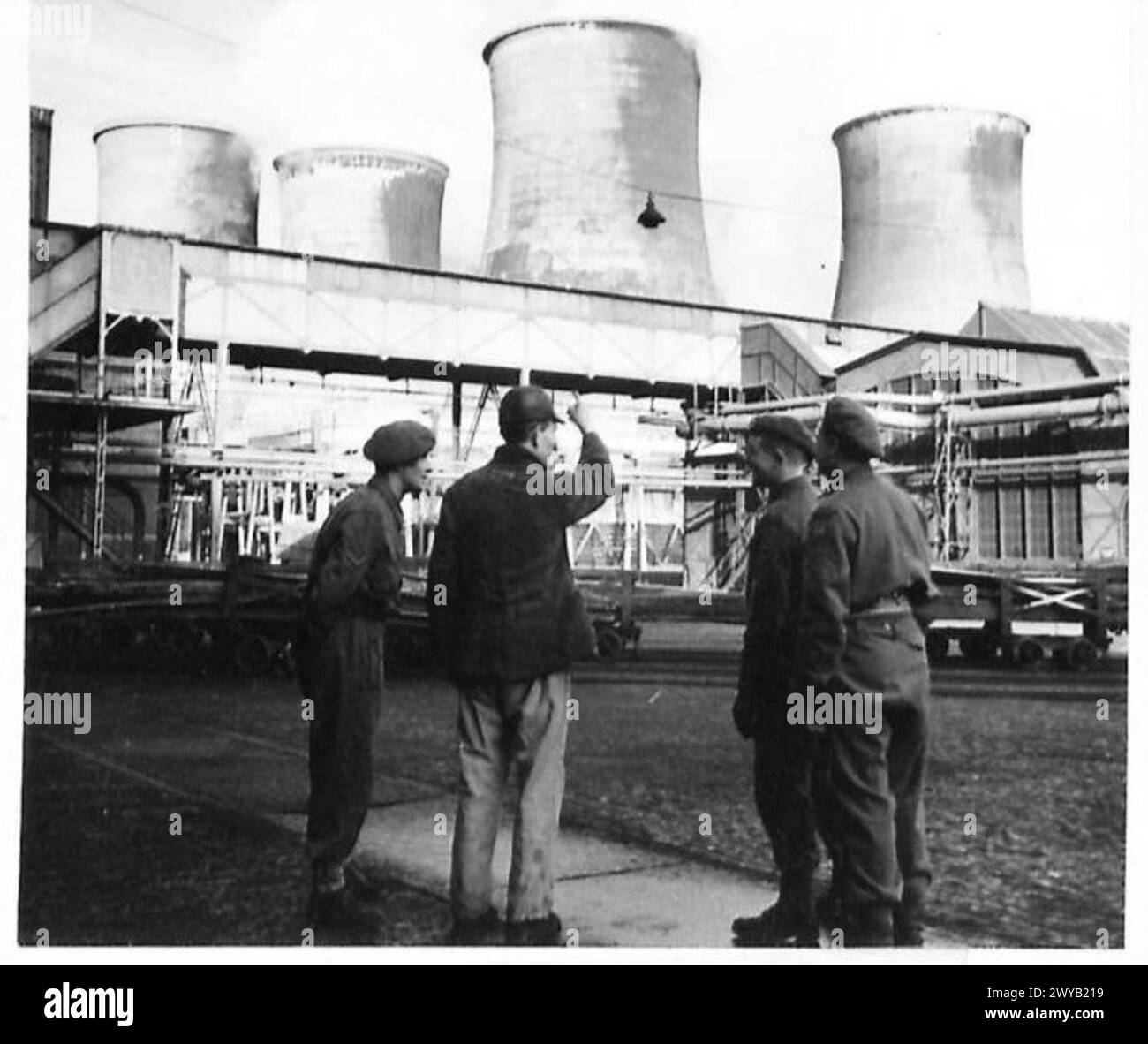 British soldiers visit a coal mine in Holland, observing cooling vats ...