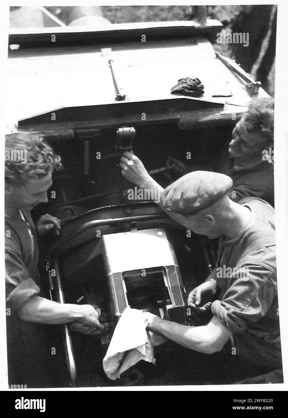 TANK MEN ENJOY A WELL-EARNED REST - Original wartime caption: The crew of an SP anti-tank gun ...