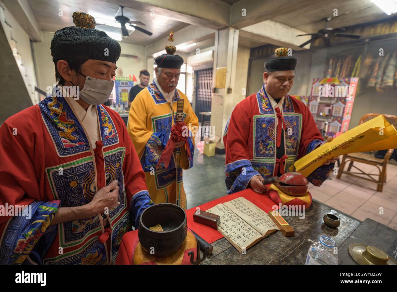 A traditional shaman performing a ritual with offerings to the ...