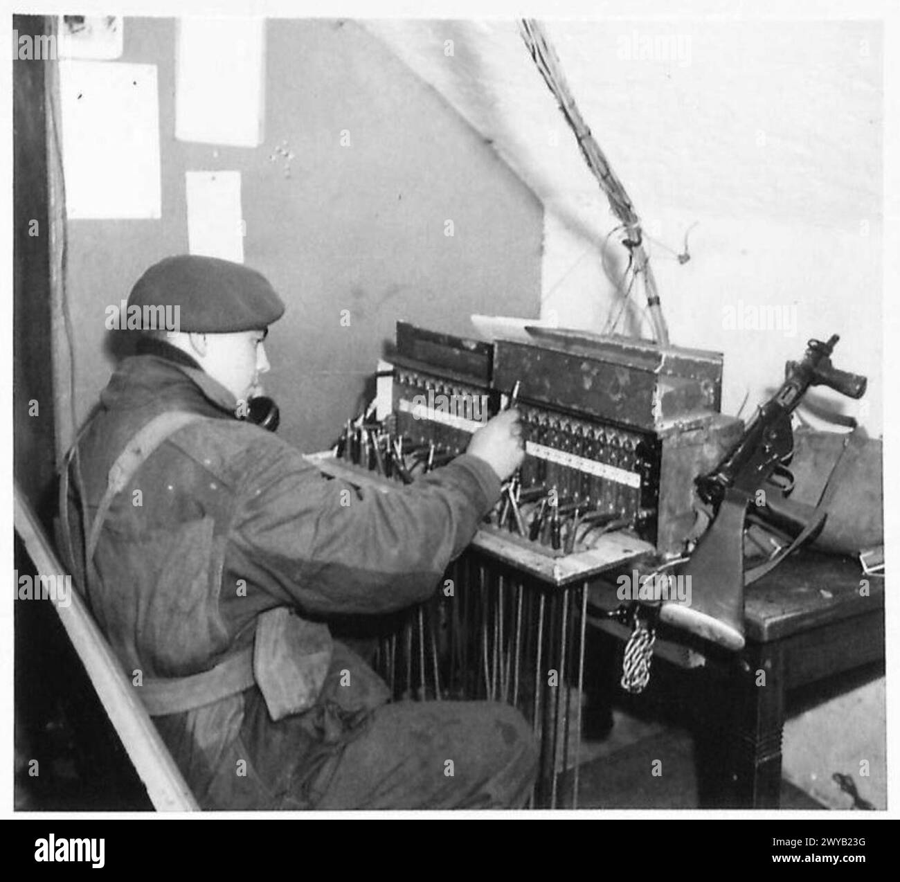 A British Army telephone exchange room shows signal equipment used for ...