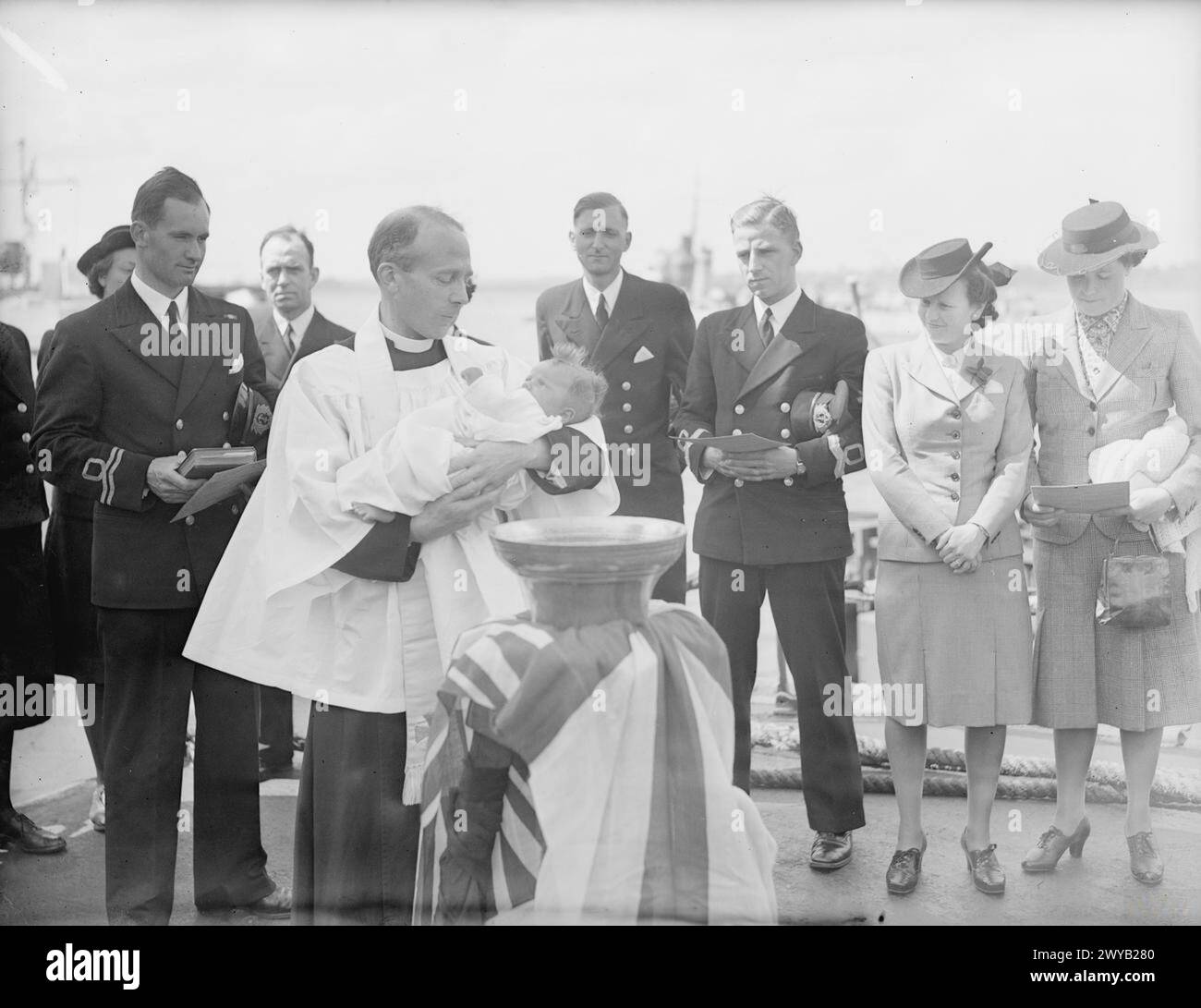 ROGER DONALD IS CHRISTENED ABOARD SHIP. 13 JUNE 1943, ABOARD HM TRAWLER ...