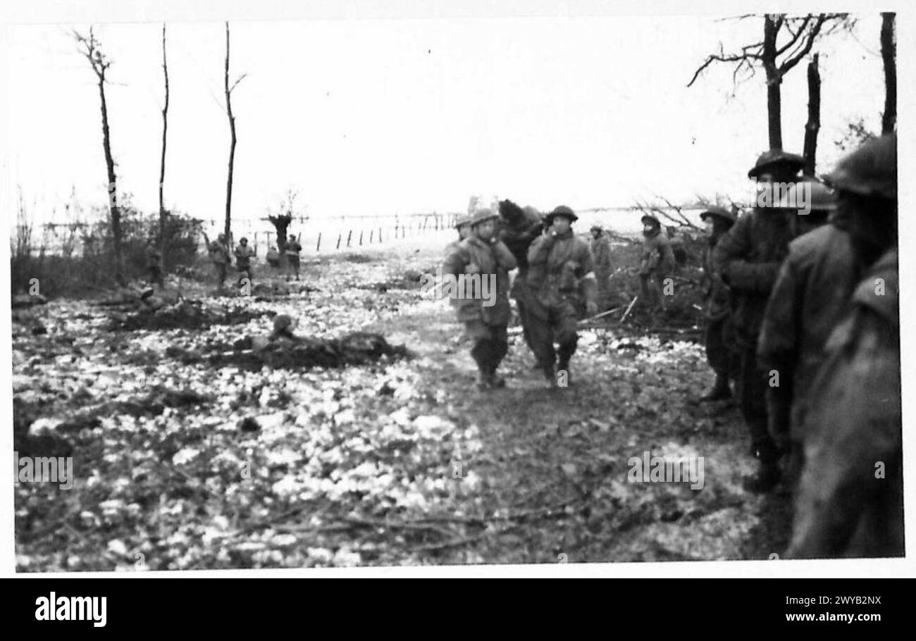 12 CORPS ADVANCE - Original wartime caption: Bringing back wounded ...