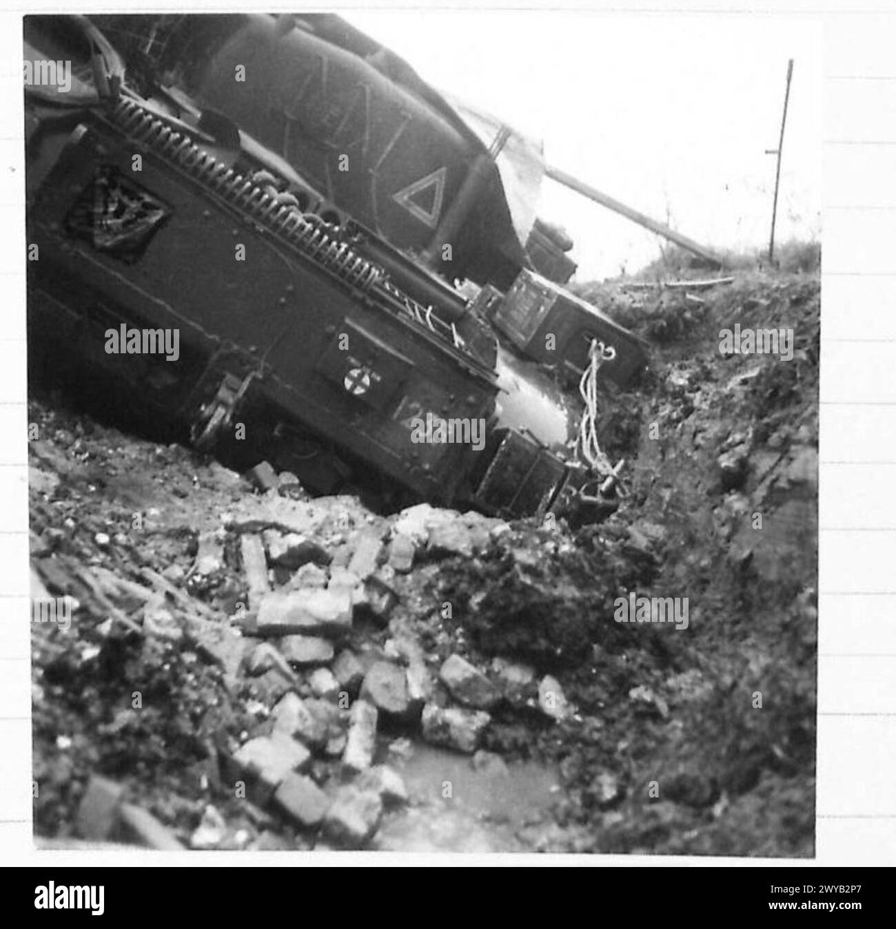 TANKS OF 11 ARMOURED DIV - Original wartime caption: Churchill tank bogged in the mud, having ...