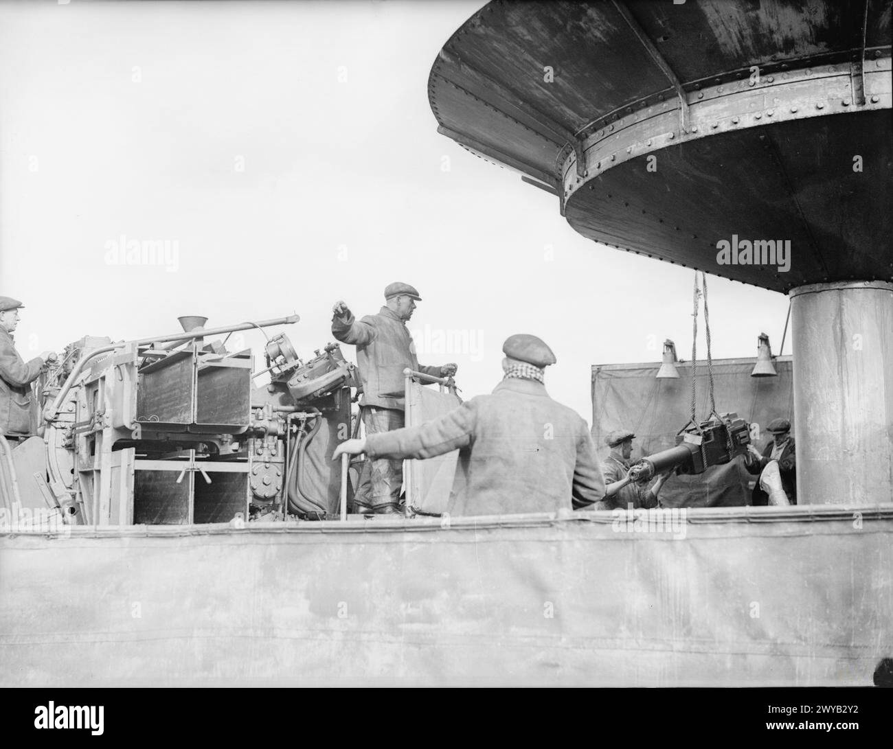 A multiple pom-pom anti-aircraft gun is hoisted on board HMS Repulse ...