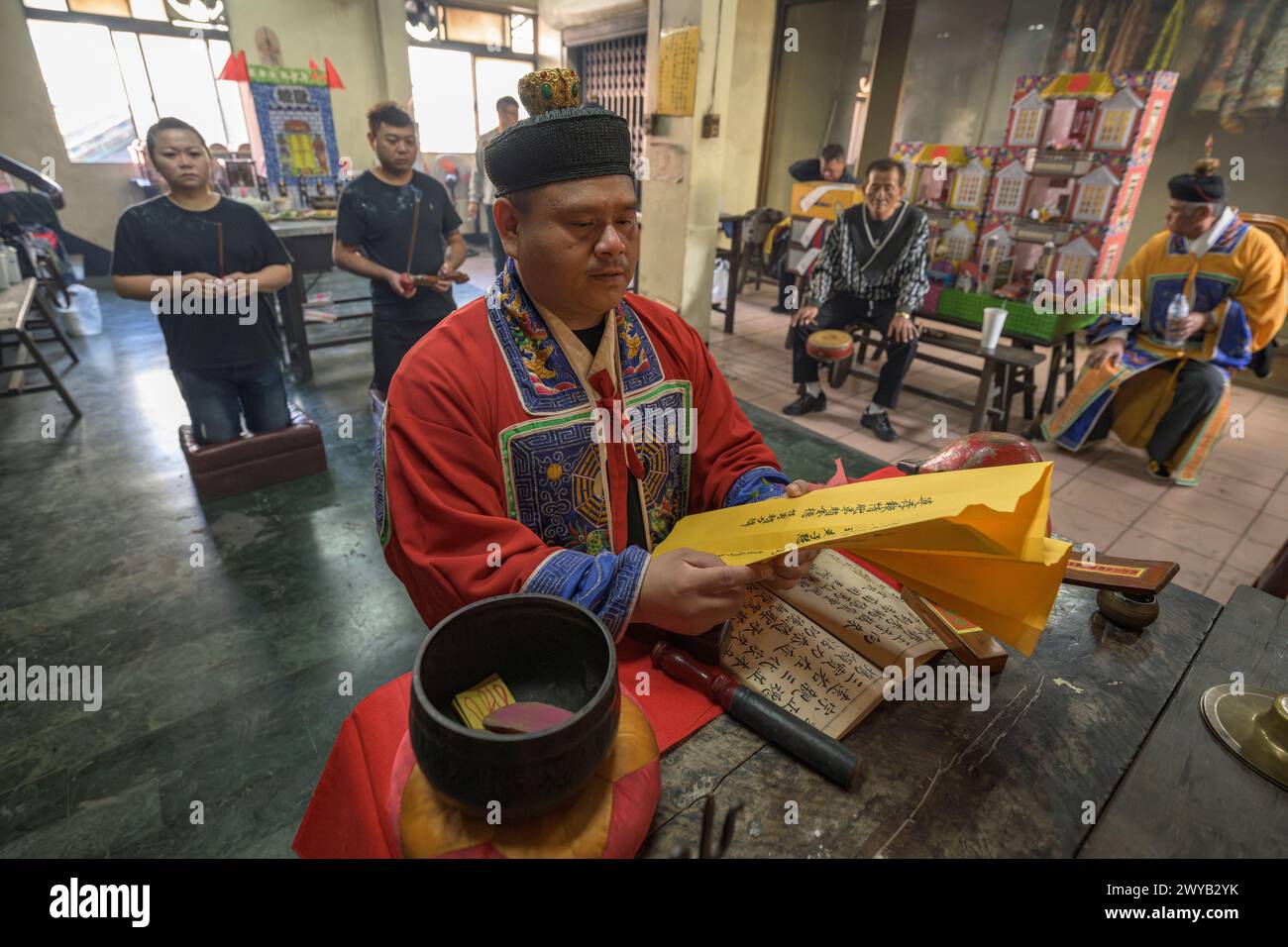 A traditional shaman performing a ritual with offerings to the ...
