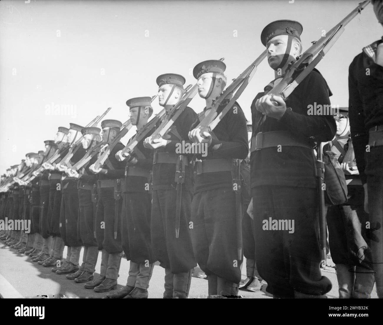 Seamen aboard HMS Rodney conduct a parade in marching order with rifles ...