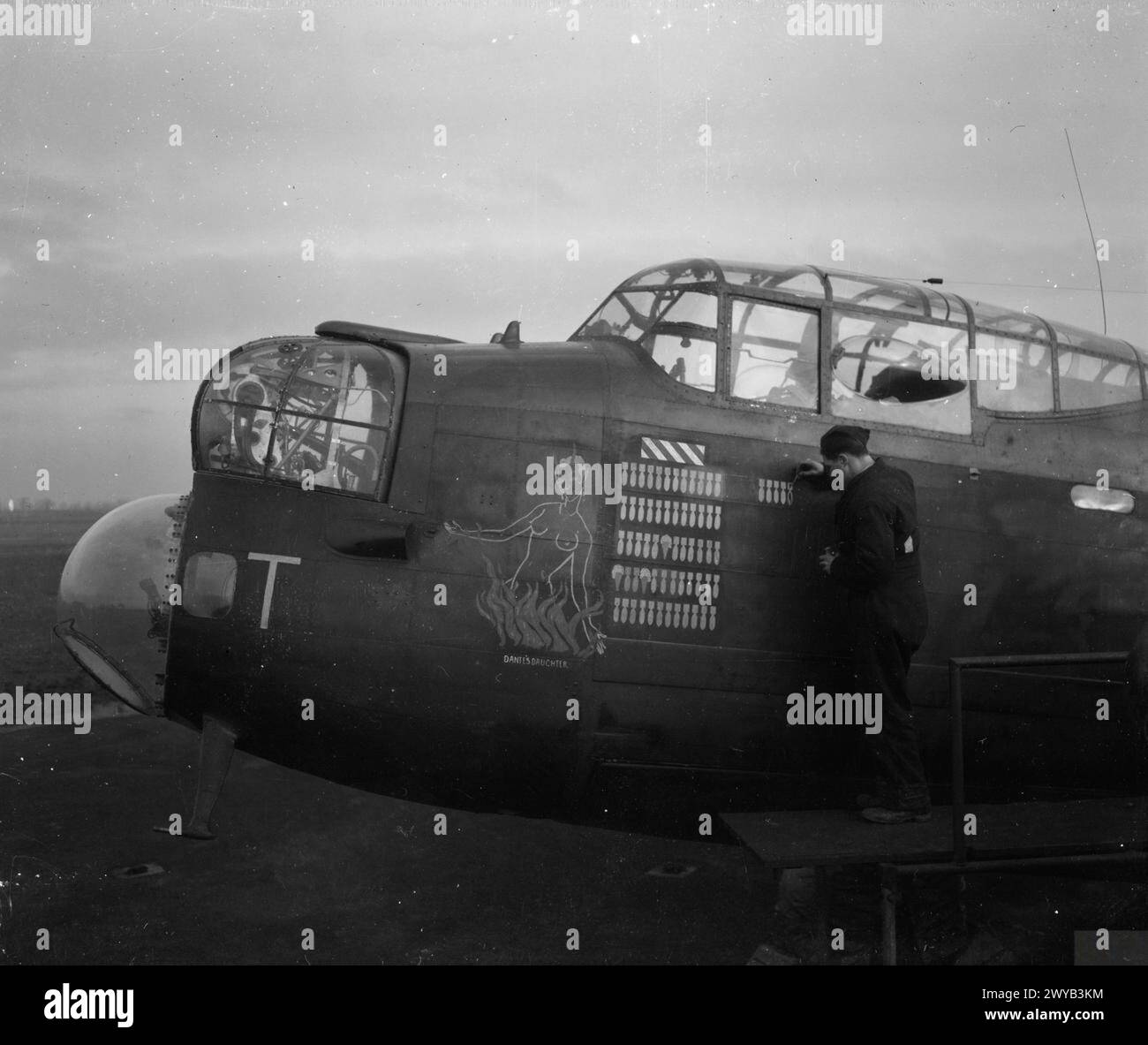 LAC E Turner paints the 65th raid symbol on Avro Lancaster B Mark III ...