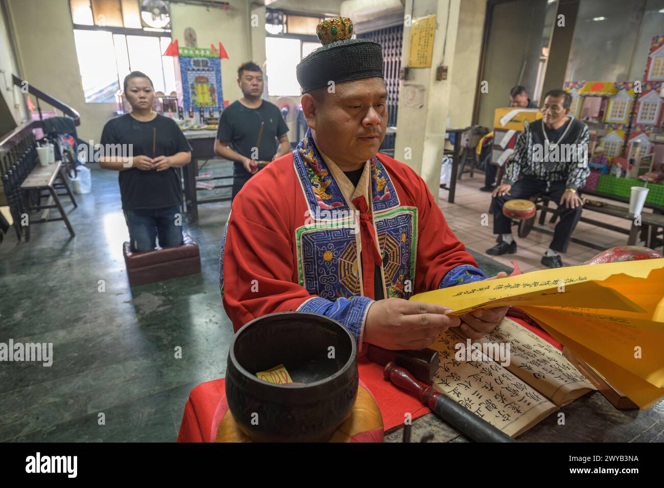 A traditional shaman performing a ritual with offerings to the ...