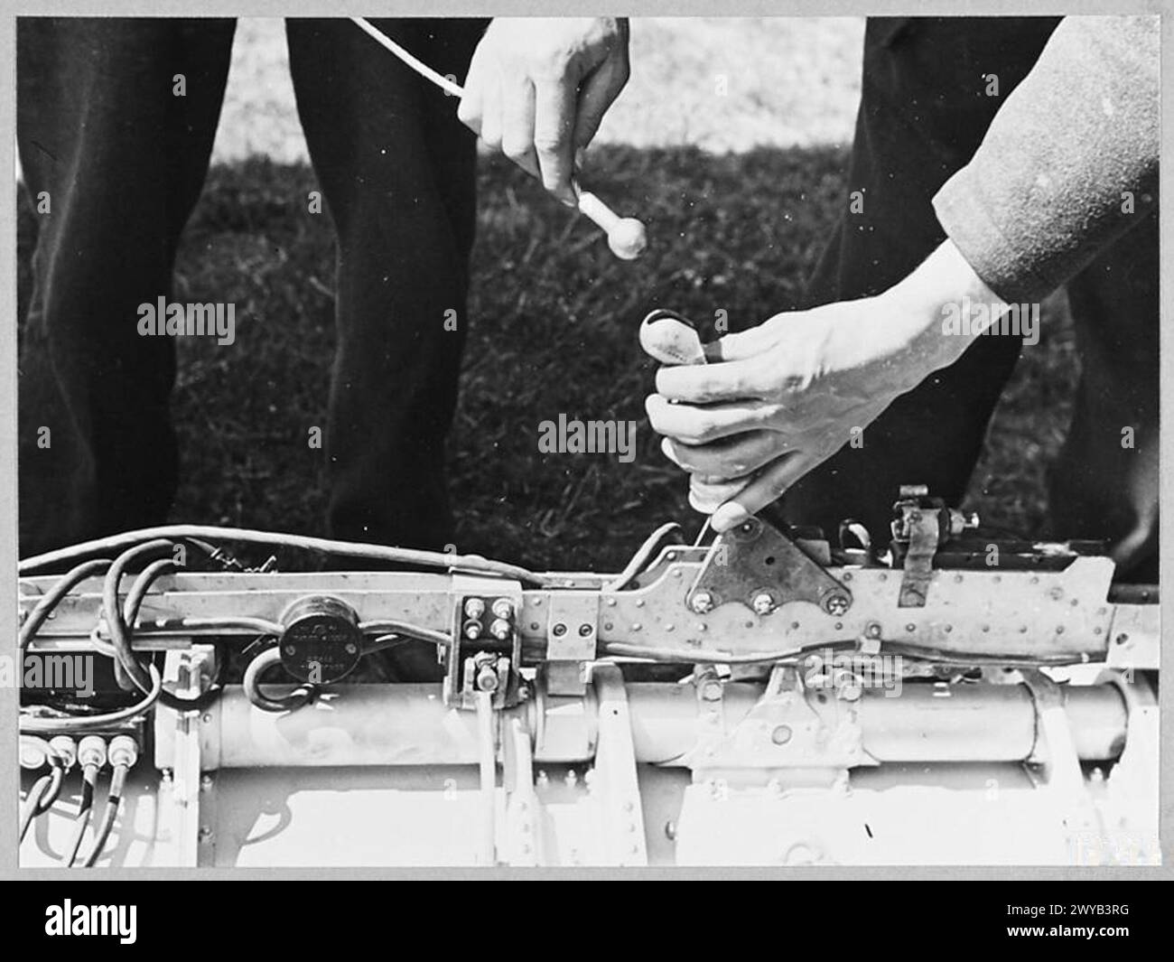 R.A.F. PERSONNEL PREPARING FIRE-BOMBS FOR USE IN RAIDS OVER ENEMY ...