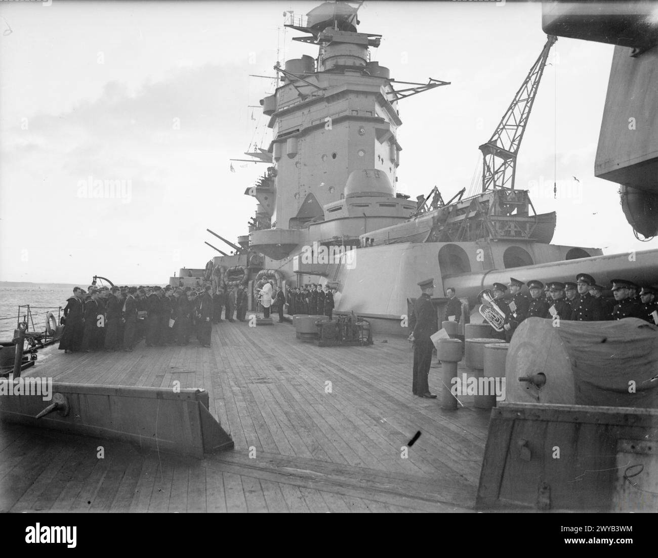 SCENES ON BOARD A BATTLESHIP AT SEA. 1940 OR 1941, ON BOARD HMS RODNEY. - Divisions on the ...