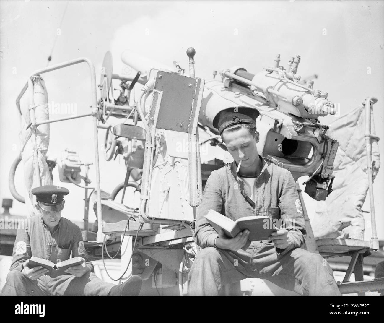 BOOKS FOR THE NAVY. 20 AUGUST 1942. - Men on board a warship enjoying ...