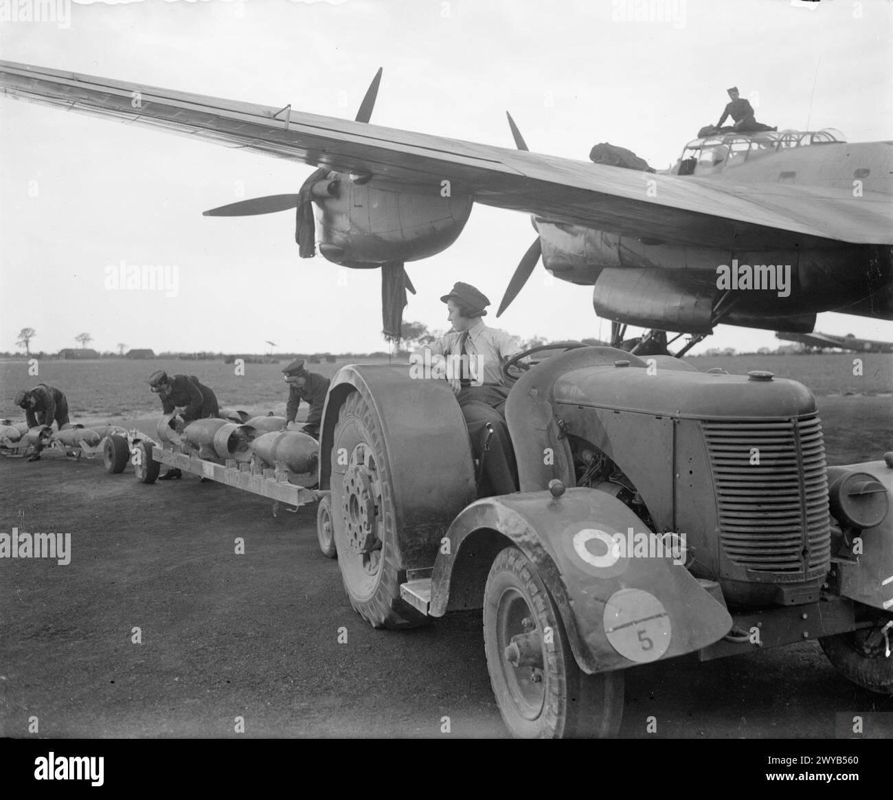 WORK OF WAAF AT BOMBER STATIONS: MOTOR TRANSPORT DRIVER AT THE WHEEL OF ...
