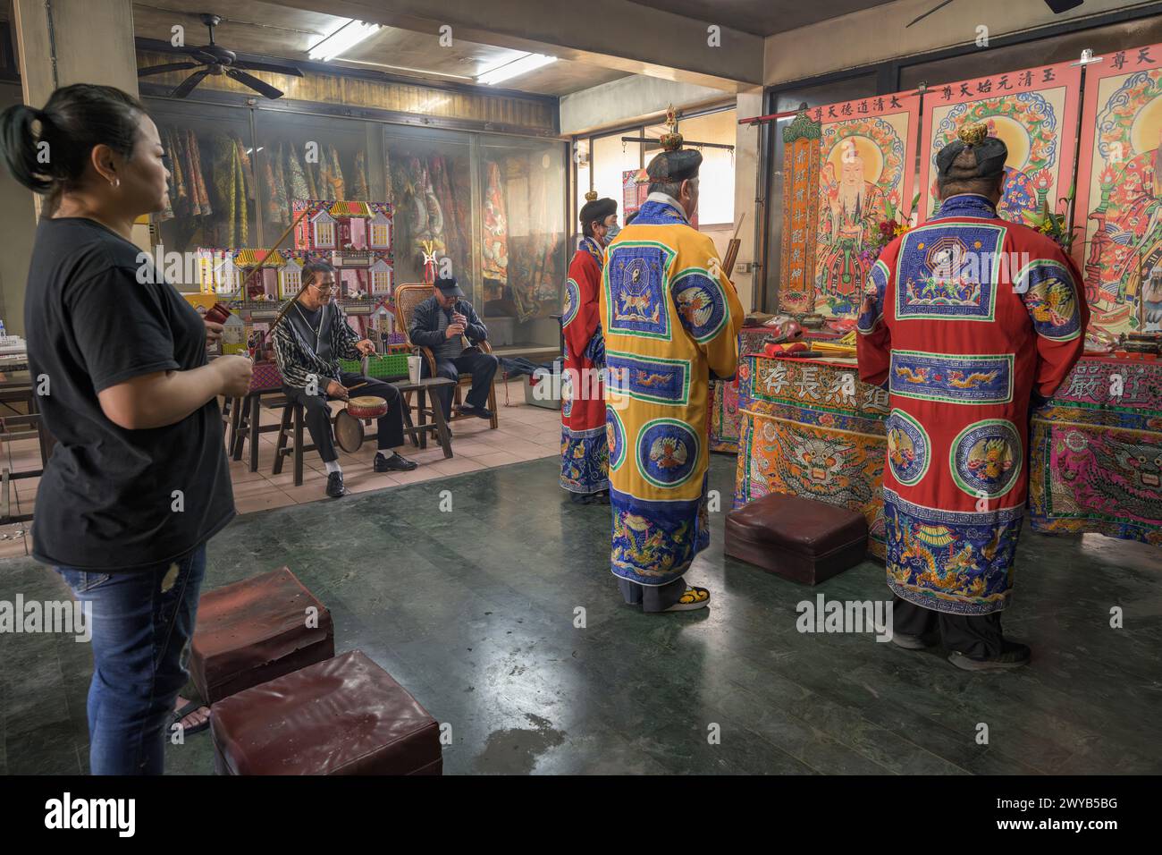 A traditional shaman performing a ritual with offerings to the ...