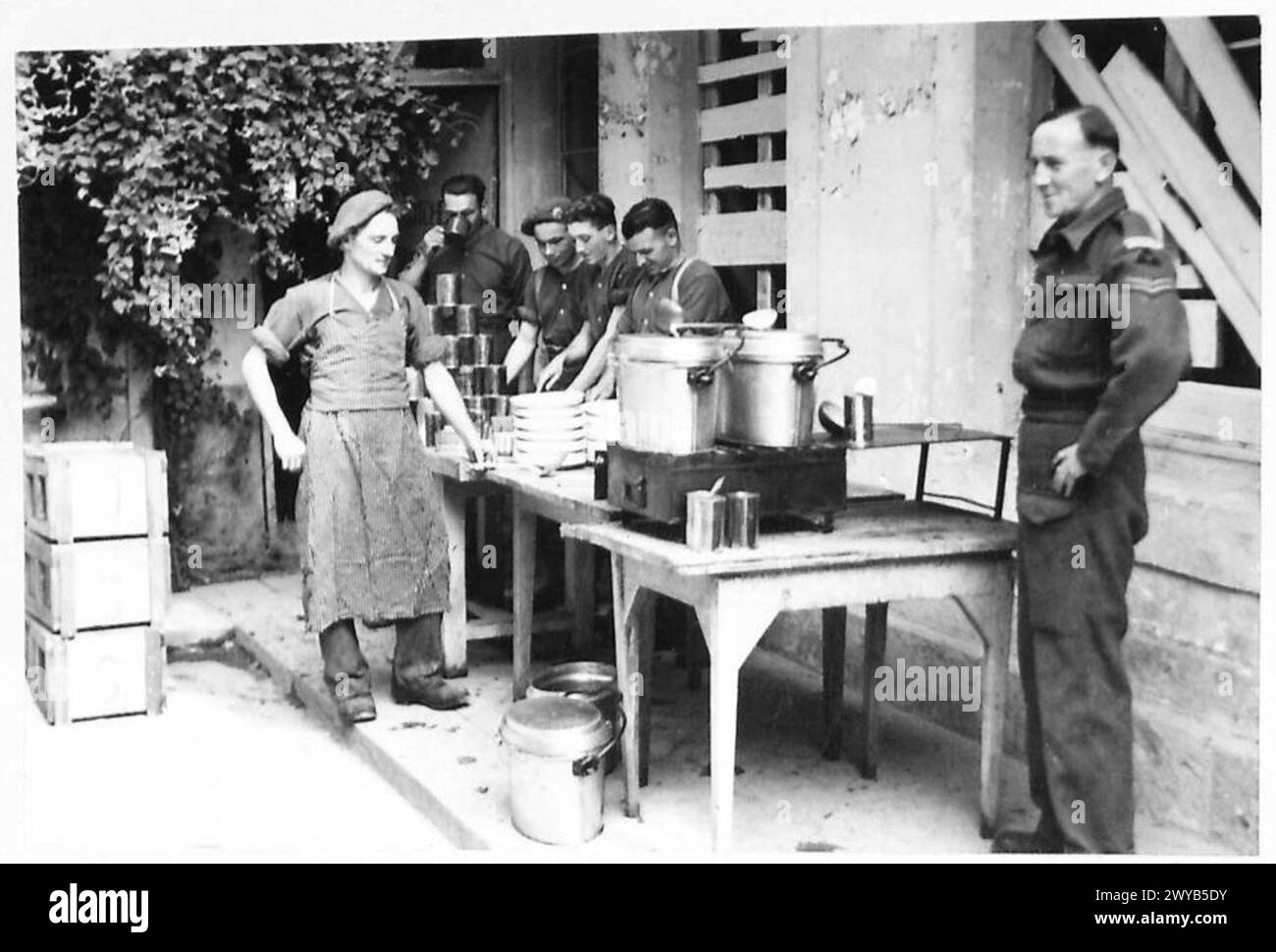 Corporal Cains of Kilburn supervises the cookhouse preparing rations ...