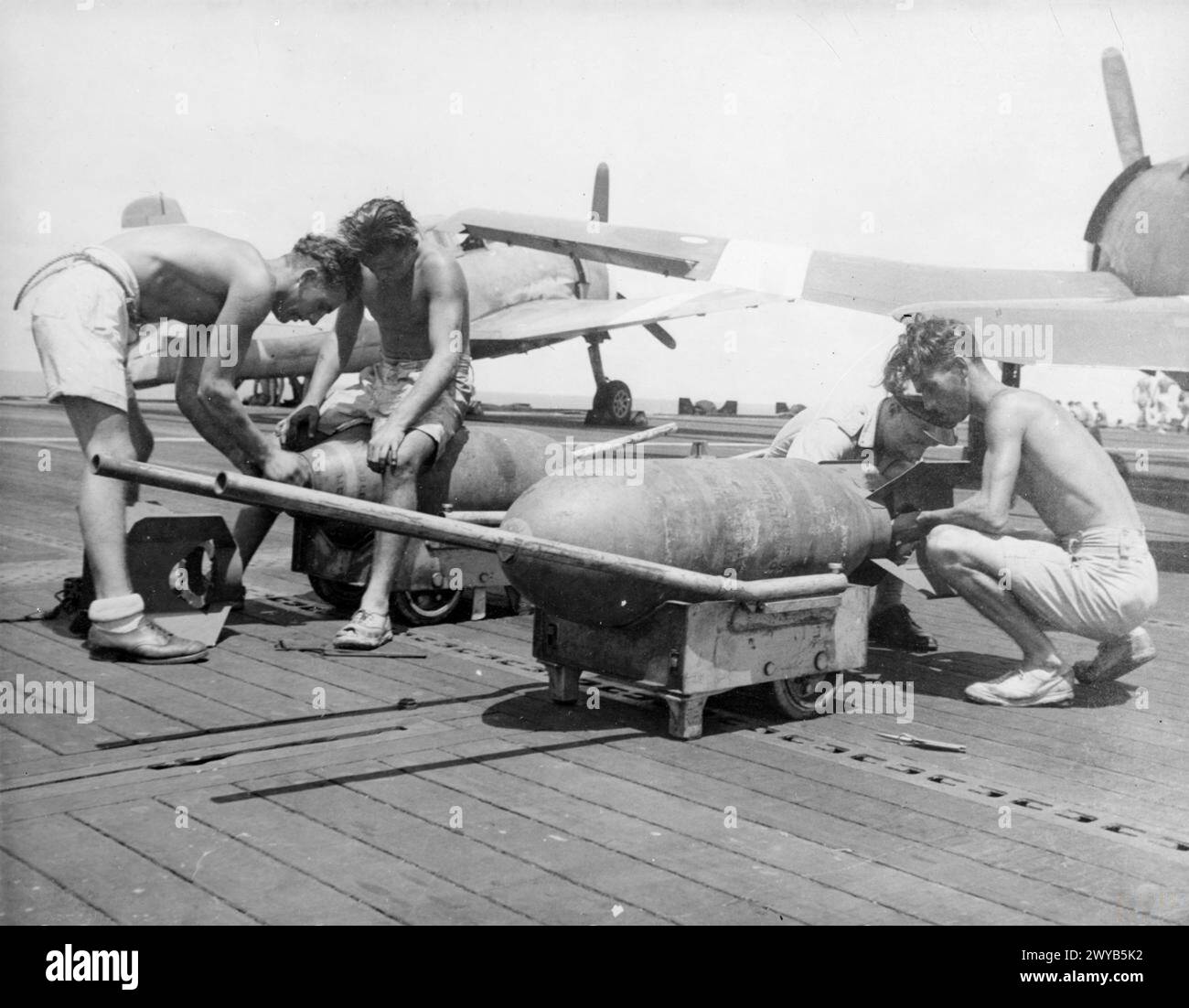 In March 1945, aboard HMS Ameer, armourer ratings prepared 500 lb bombs ...