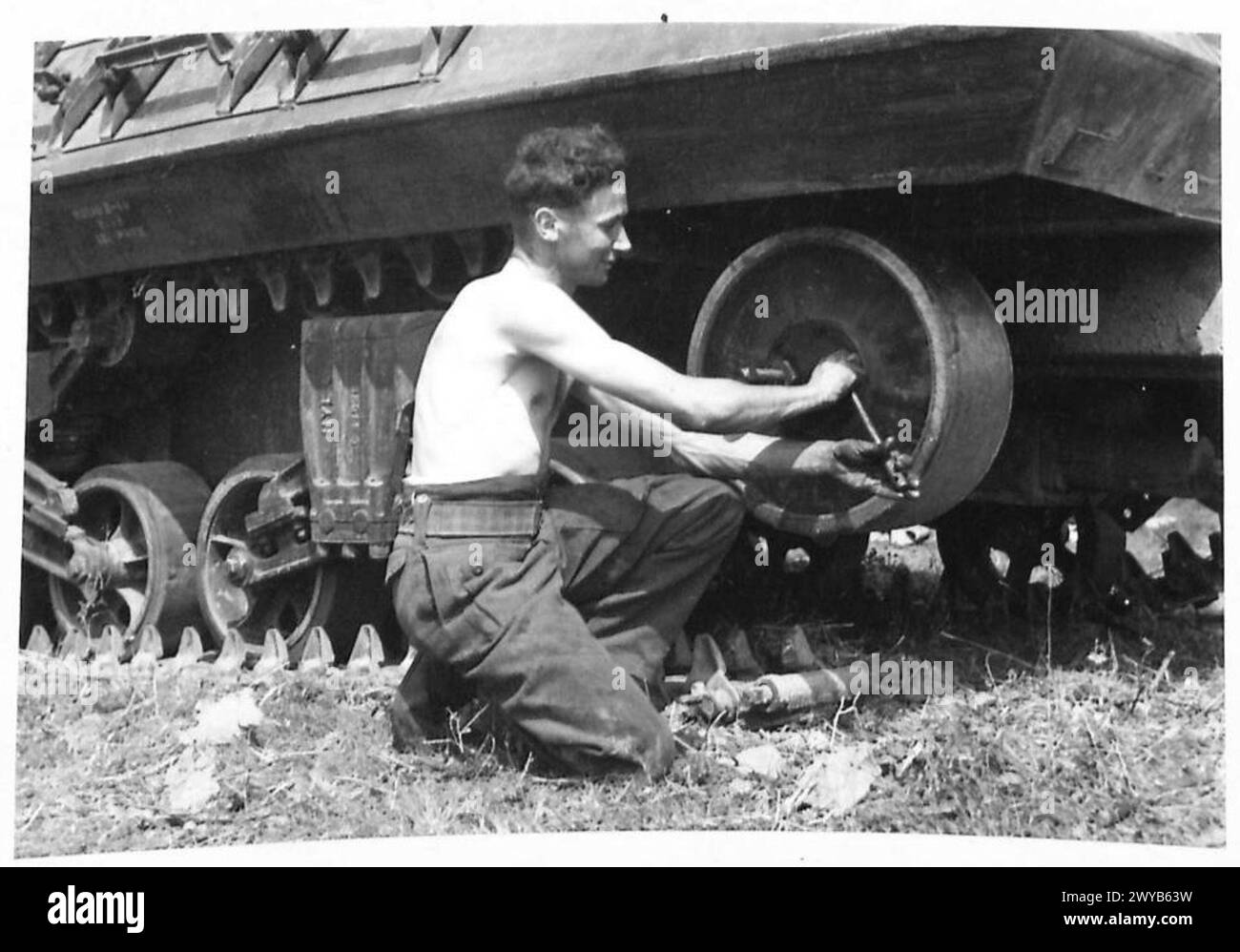 TANK MEN ENJOY A WELL-EARNED REST - Original wartime caption: L/Bdr. G. Cannell of Beccles ...