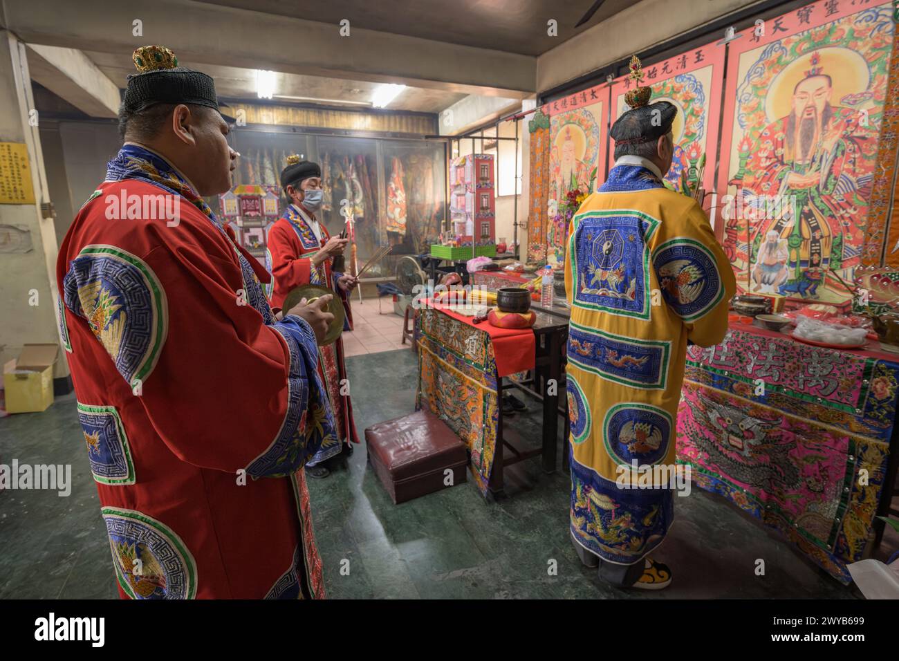 A traditional shaman performing a ritual with offerings to the ...