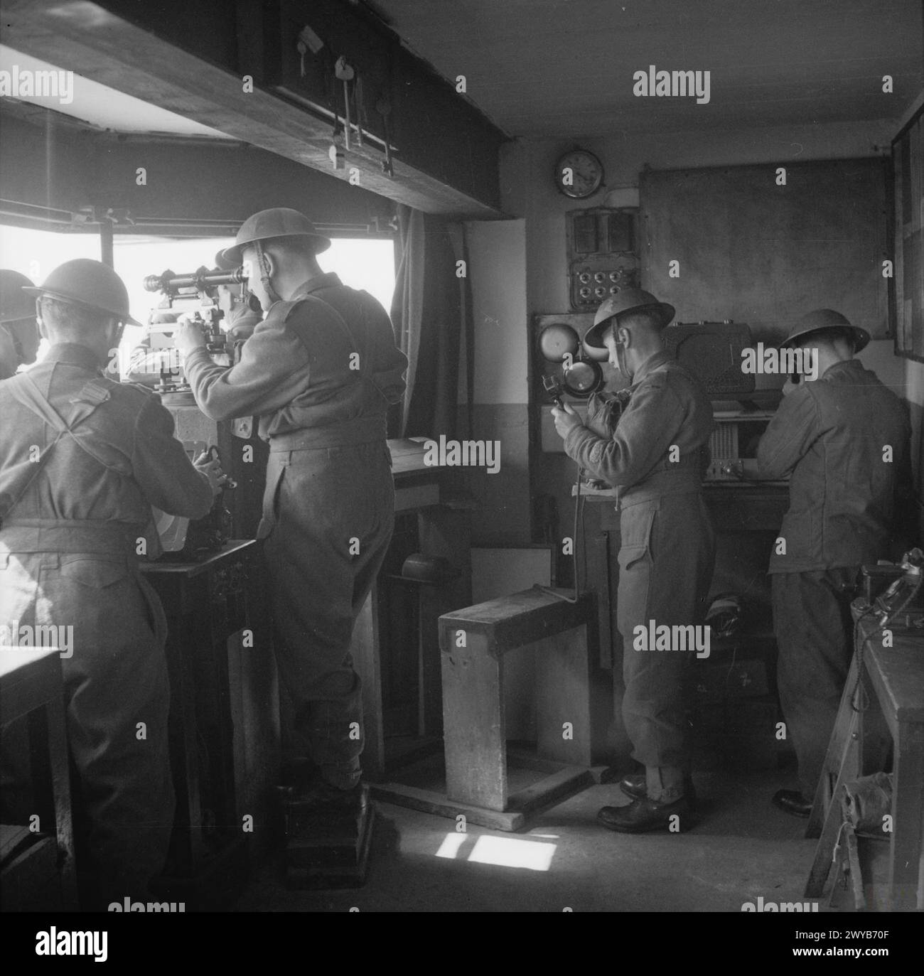Six-inch coastal defense battery positions and equipment on a shoreline ...