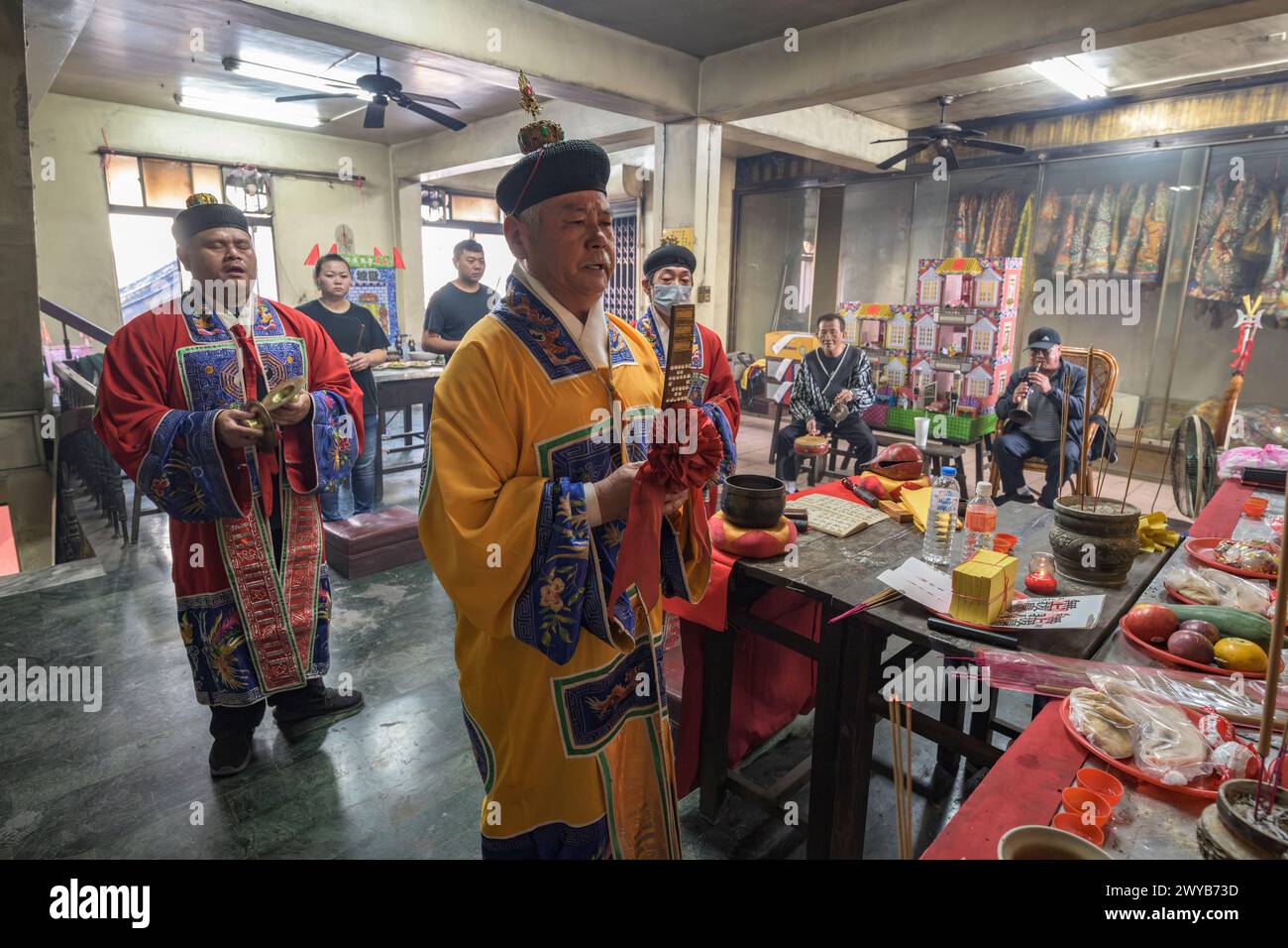 A traditional shaman performing a ritual with offerings to the ...