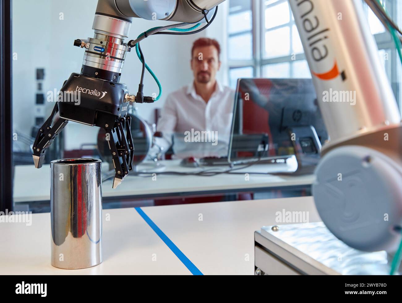 Robot composed of two pieces, a robotic arm, motorized by a clamp to ...