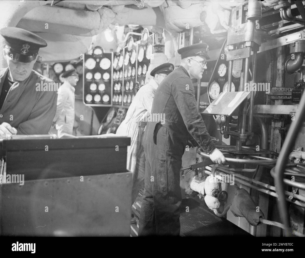 An engine room aboard the battleship HMS Prince of Wales is documented ...
