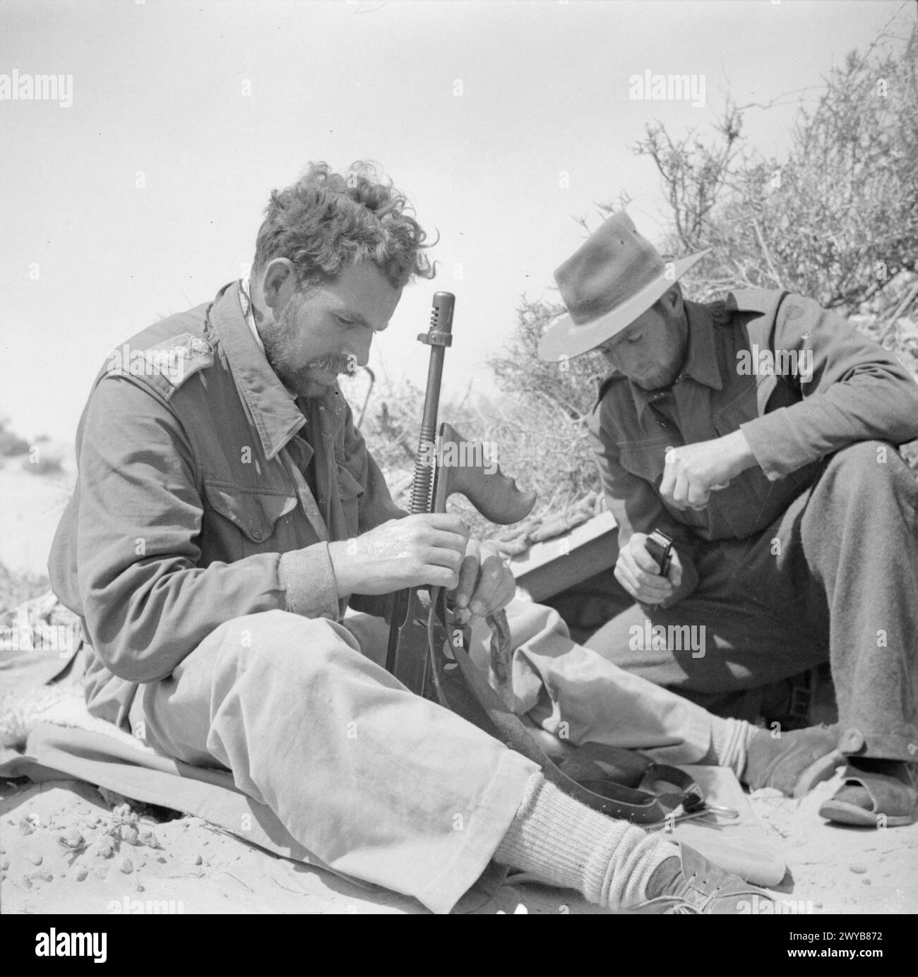 An LRDG patrol of the British Army cleans their weapons during a break ...