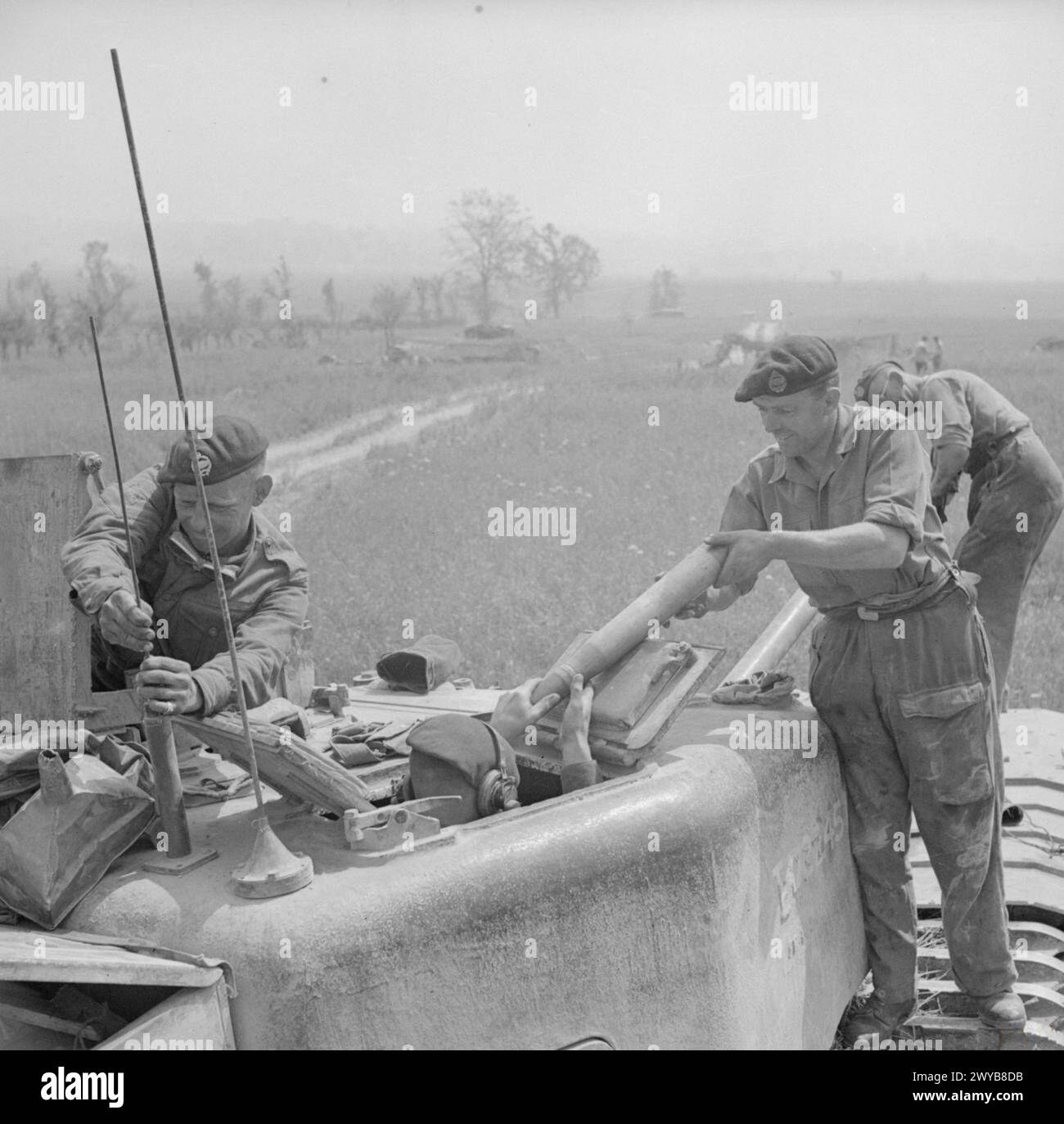 Ammunition is passed into the turret of a Churchill tank of the 25th ...