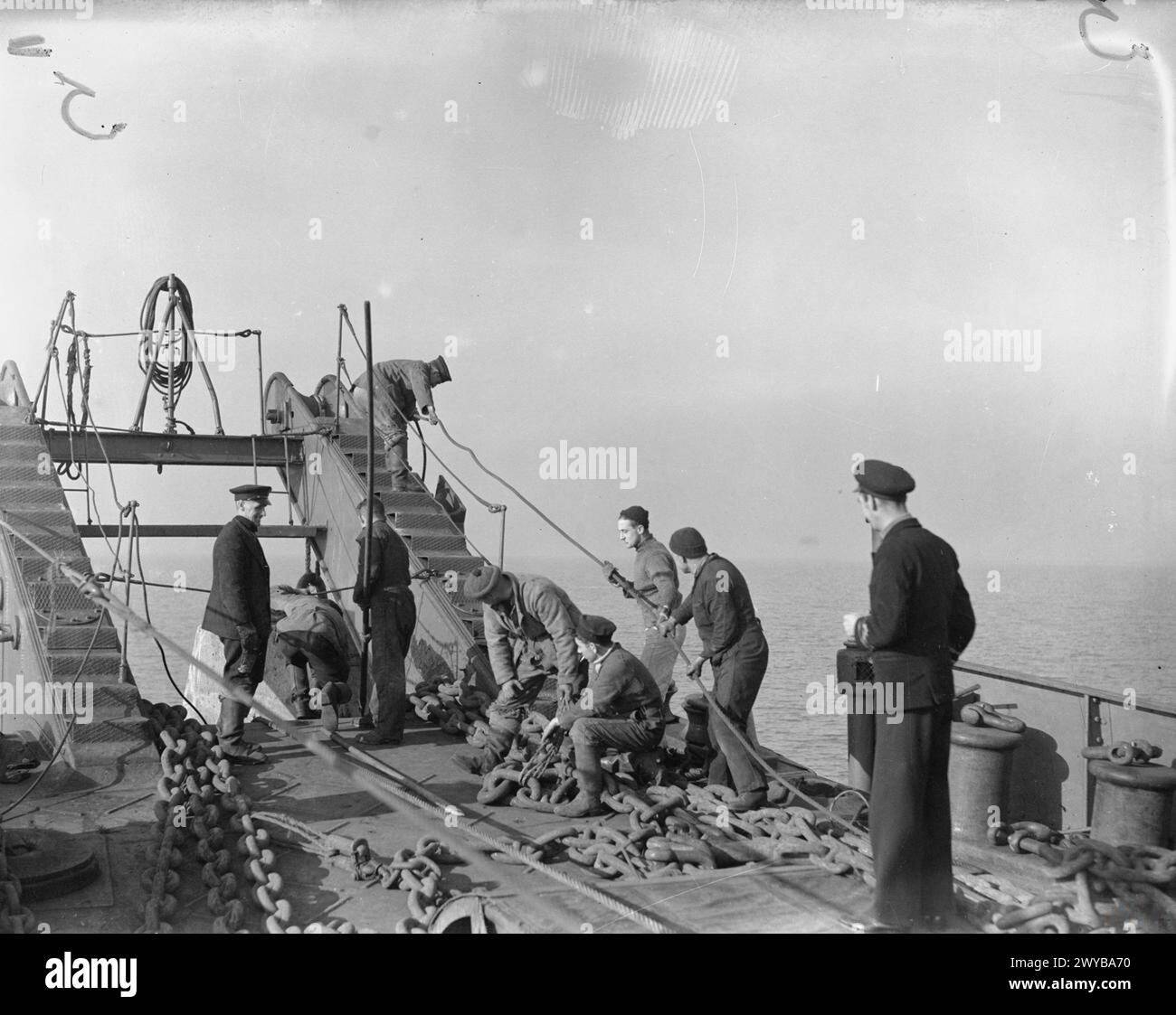 BOOM DEFENCE. OCTOBER 1941, ROSYTH. MEN WHO ARE USED TO HANDLING ...