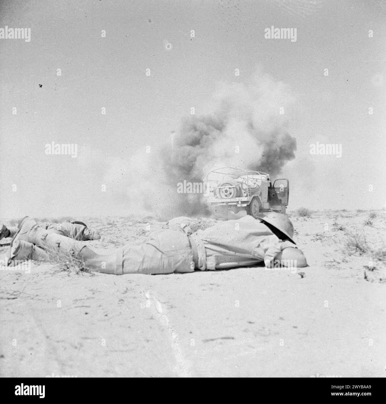 British Army troops lie on the ground and cover their heads as their ...