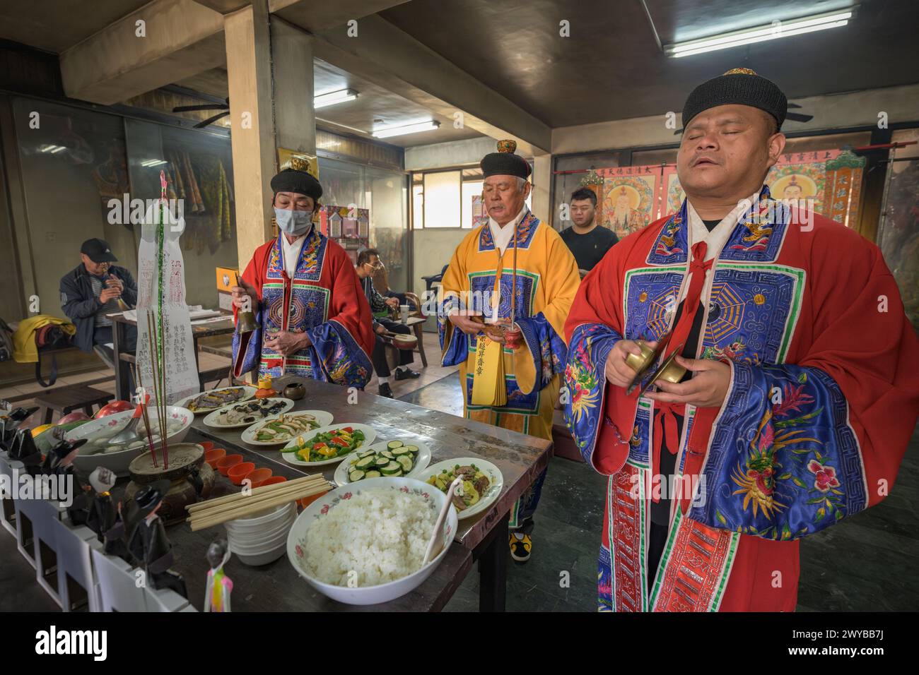 A traditional shaman performing a ritual with offerings to the ...
