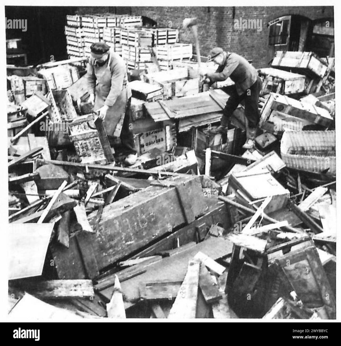 SALVAGE - Original wartime caption: Large quantities of wooden boxes ...