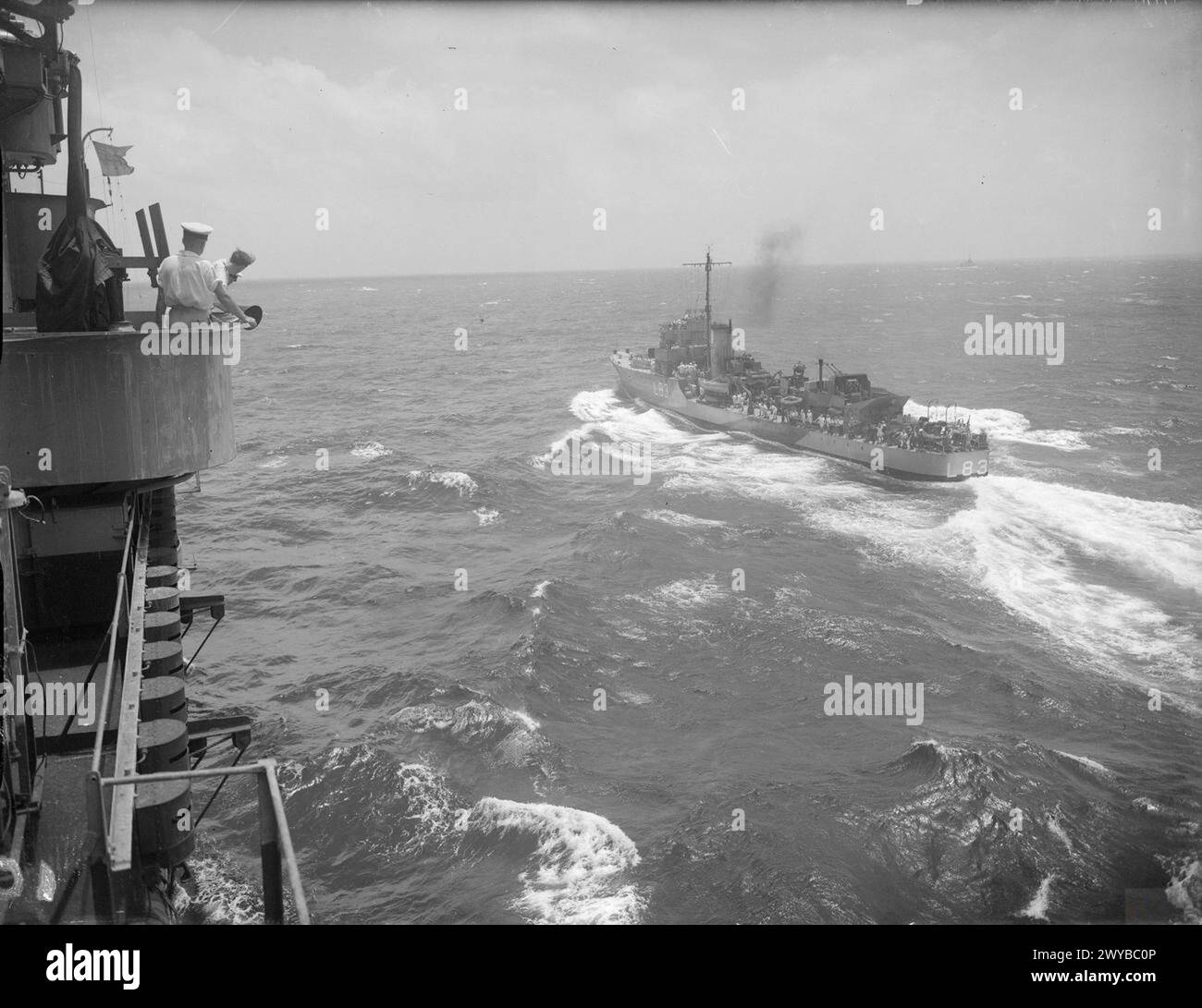 DESTROYER OILING FROM HMS ILLUSTRIOUS AT SEA. 18 OCTOBER 1942, ON BOARD ...