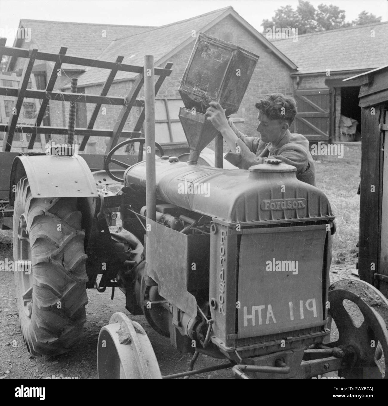 George Blackler fills a Fordson tractor with petrol at Mount Barton ...