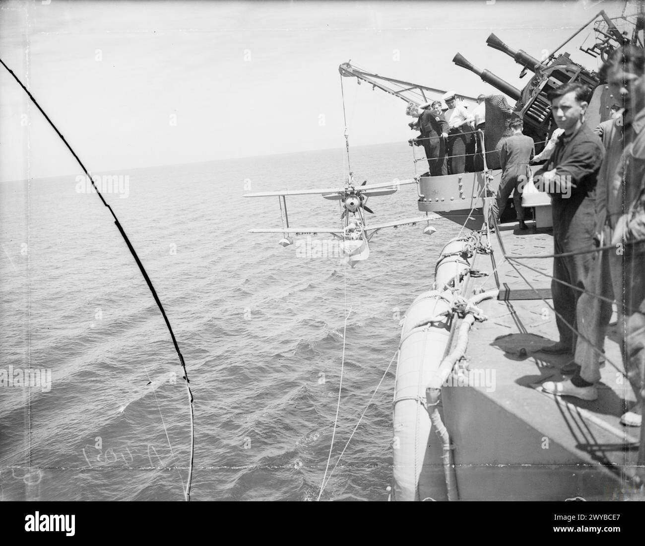 ON BOARD THE CRUISER HMS SHEFFIELD. MAY 1941, AT SEA. - A Supermarine Walrus Amphibian being ...