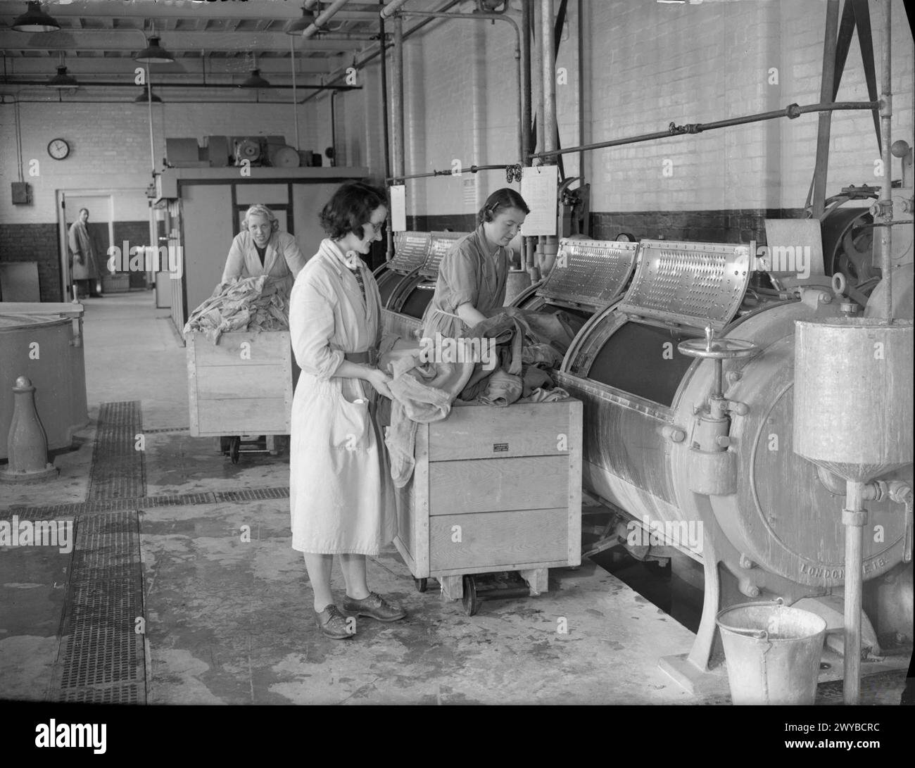 WAR INDUSTRY, UK, 1941 - Women at work in the large laundry attached to ...