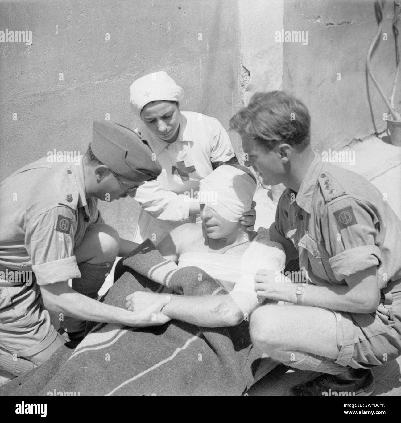 An Italian Red Cross nurse assists medical personnel of the 51st ...