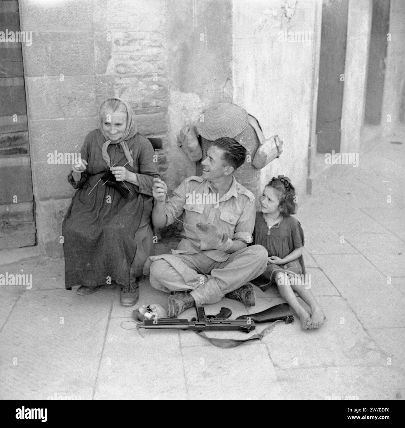 THE BRITISH ARMY IN ITALY 1944 - An old woman and a young girl keep ...