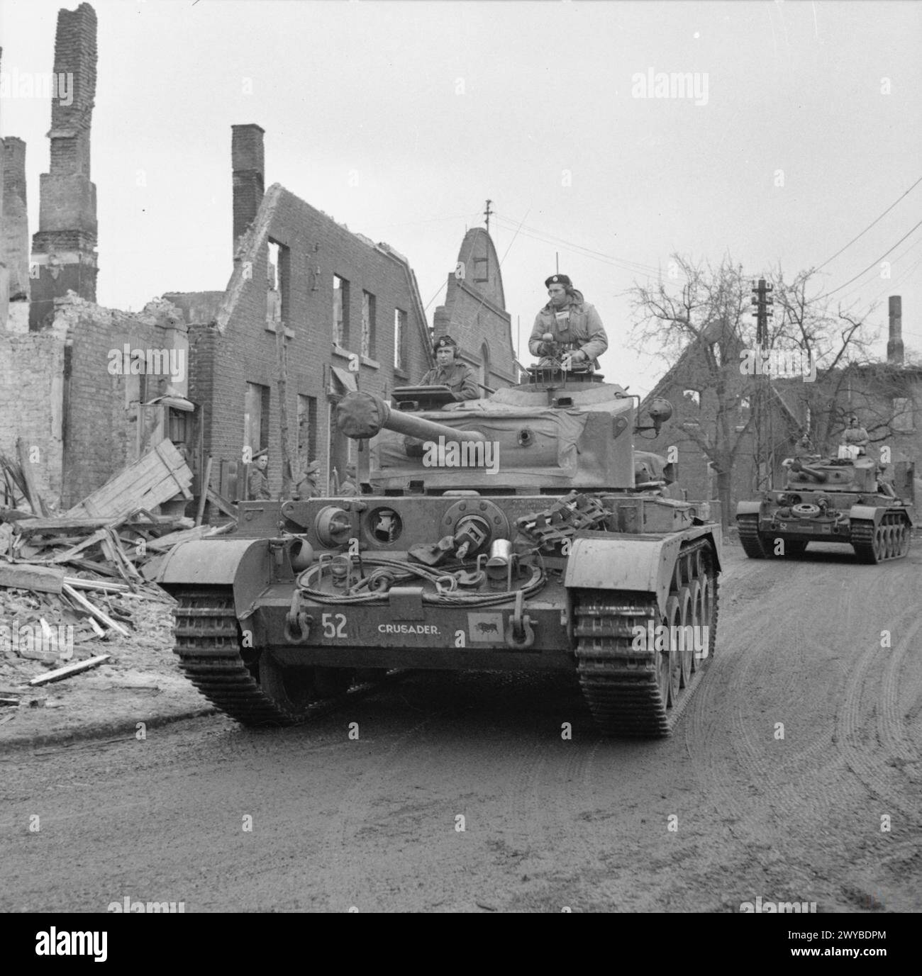 Comet tanks of the 11th Armoured Division drive through a devastated ...