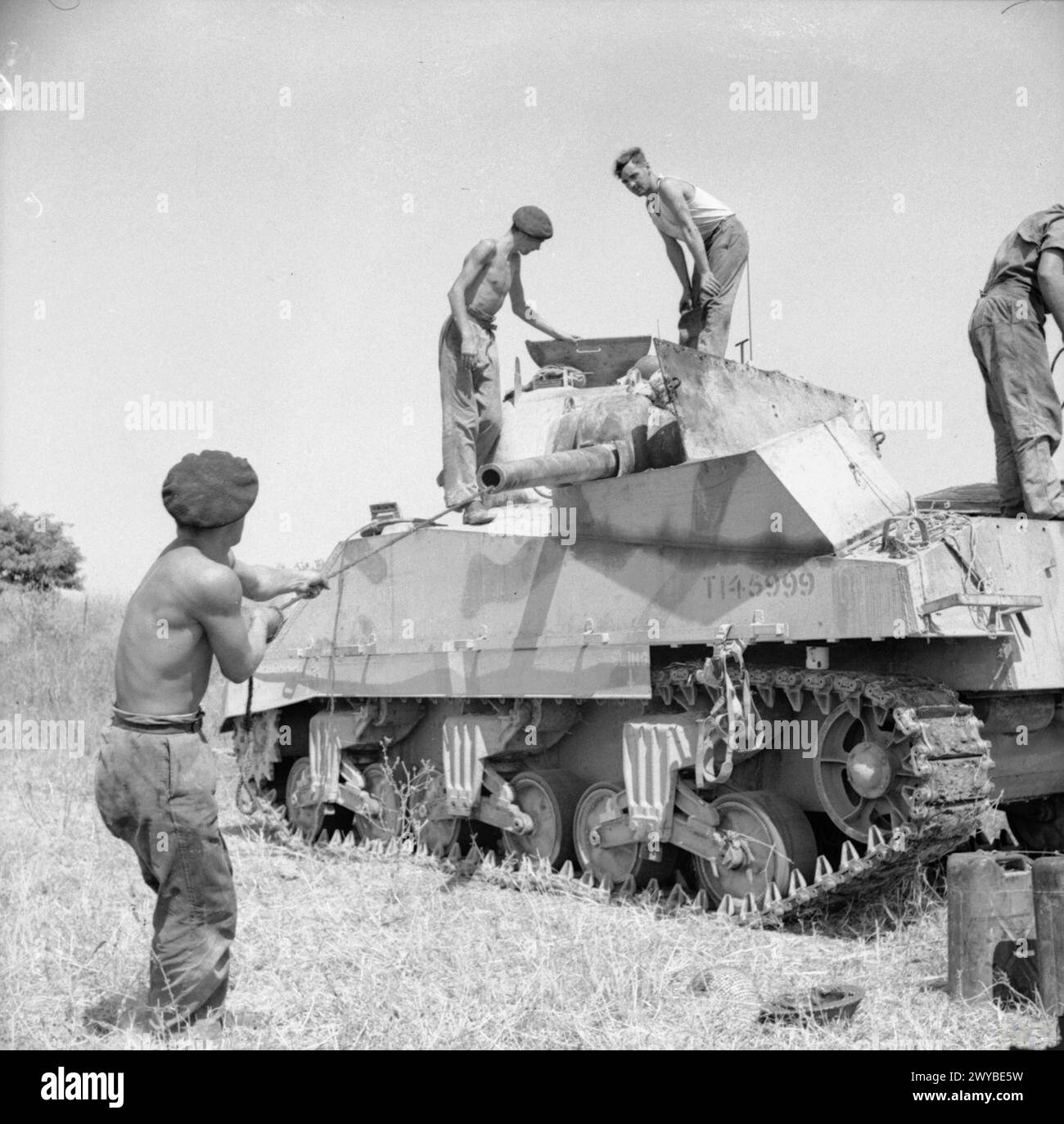 A Sherman tank crewman operates the 75mm gun following action near ...