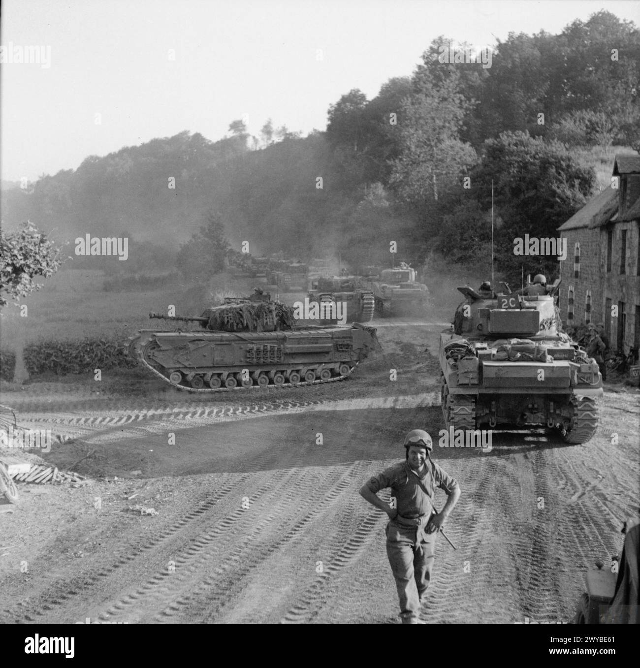 THE BRITISH ARMY IN NORMANDY 1944 - Sherman tanks heading south pass a ...