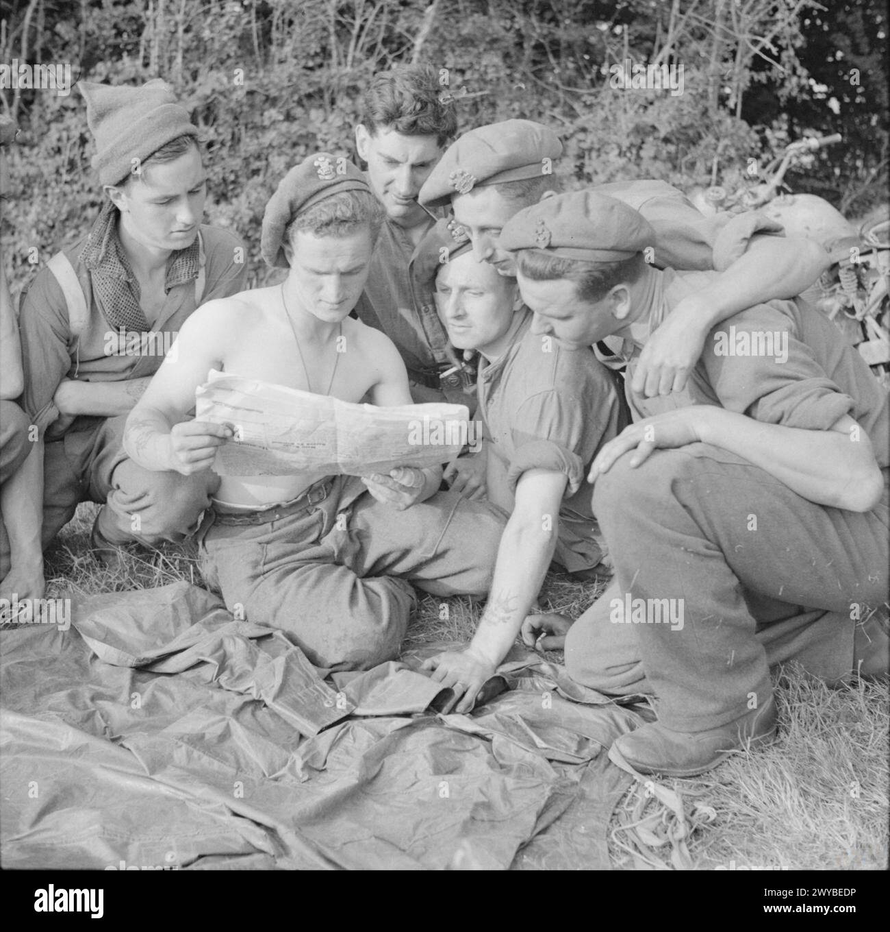 British Army soldiers read a newspaper while stationed in North-West ...