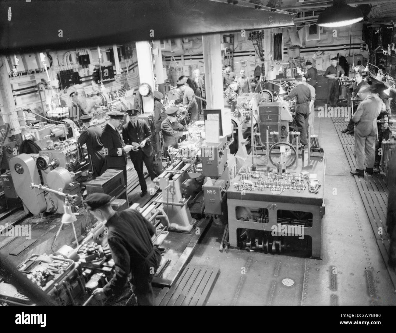 Naval engine room artificers work in the light machine shop aboard ...