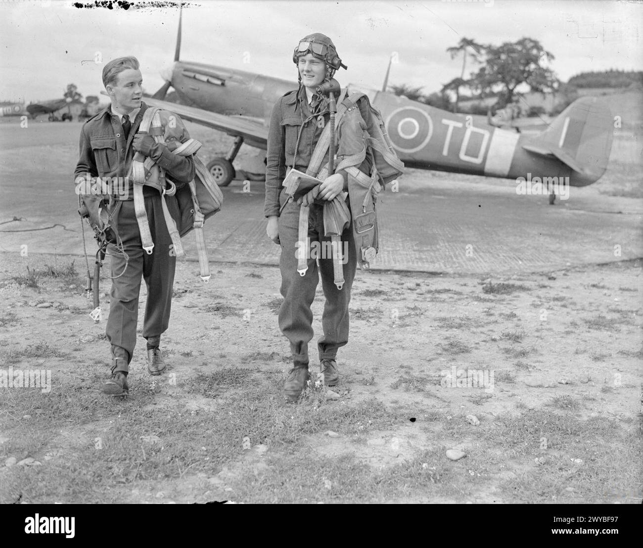 A trainee fighter pilot and his instructor review flight performance at ...