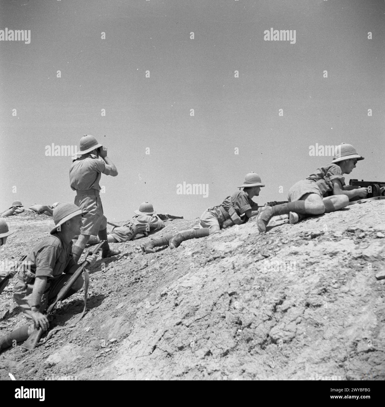 THE BRITISH ARMY IN THE MIDDLE EAST 1941 - A firing party provide cover ...