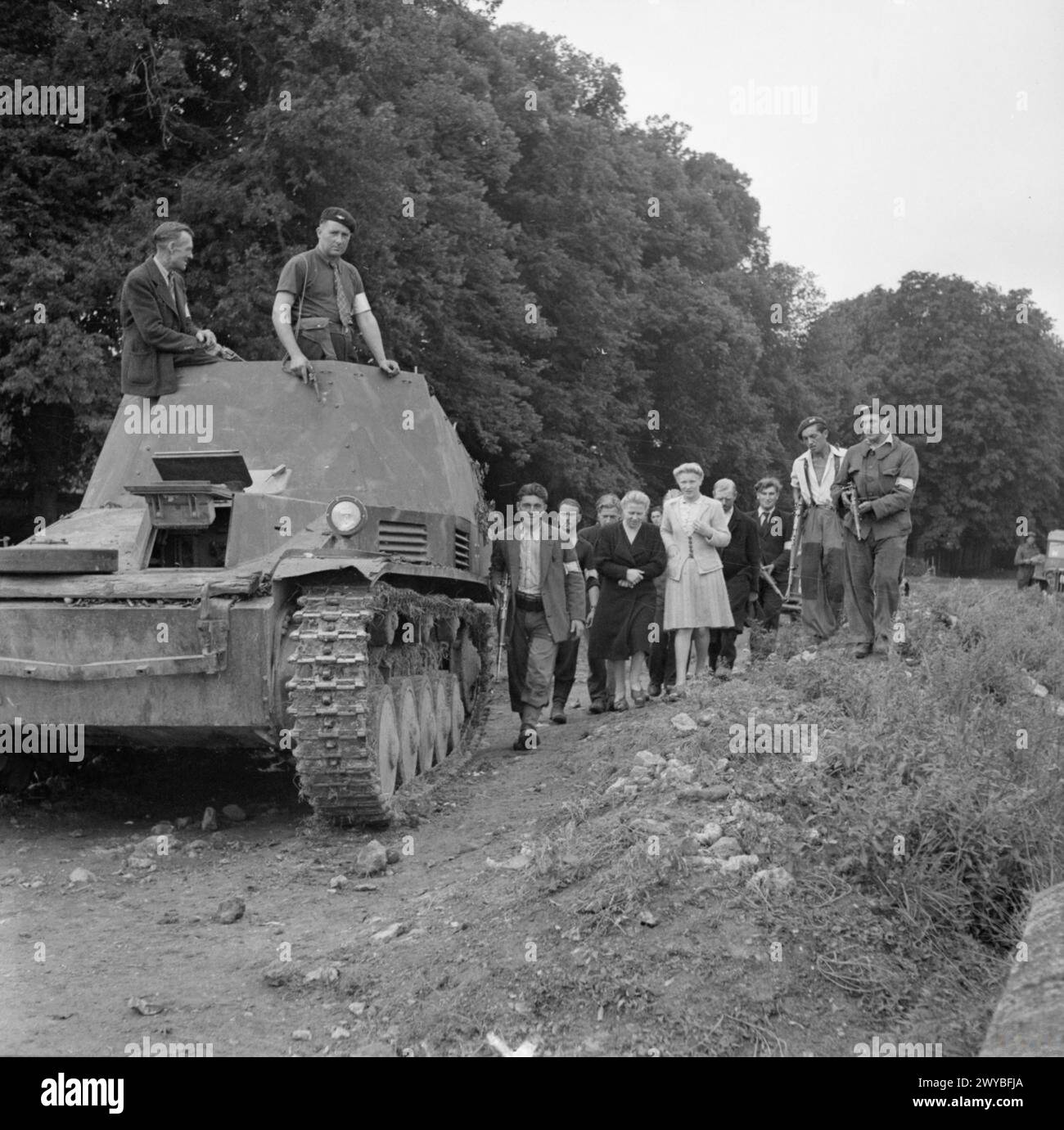 French civilians and FFI members stand with a captured German Wespe ...