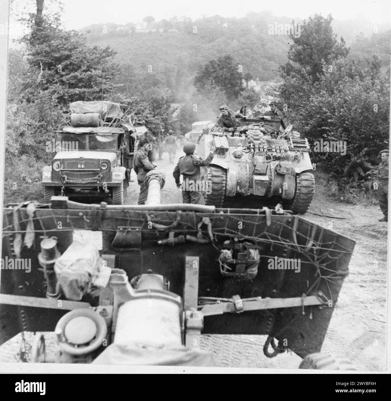THE BRITISH ARMY IN NORMANDY 1944 - A Sherman ARV, towed anti-tank guns ...