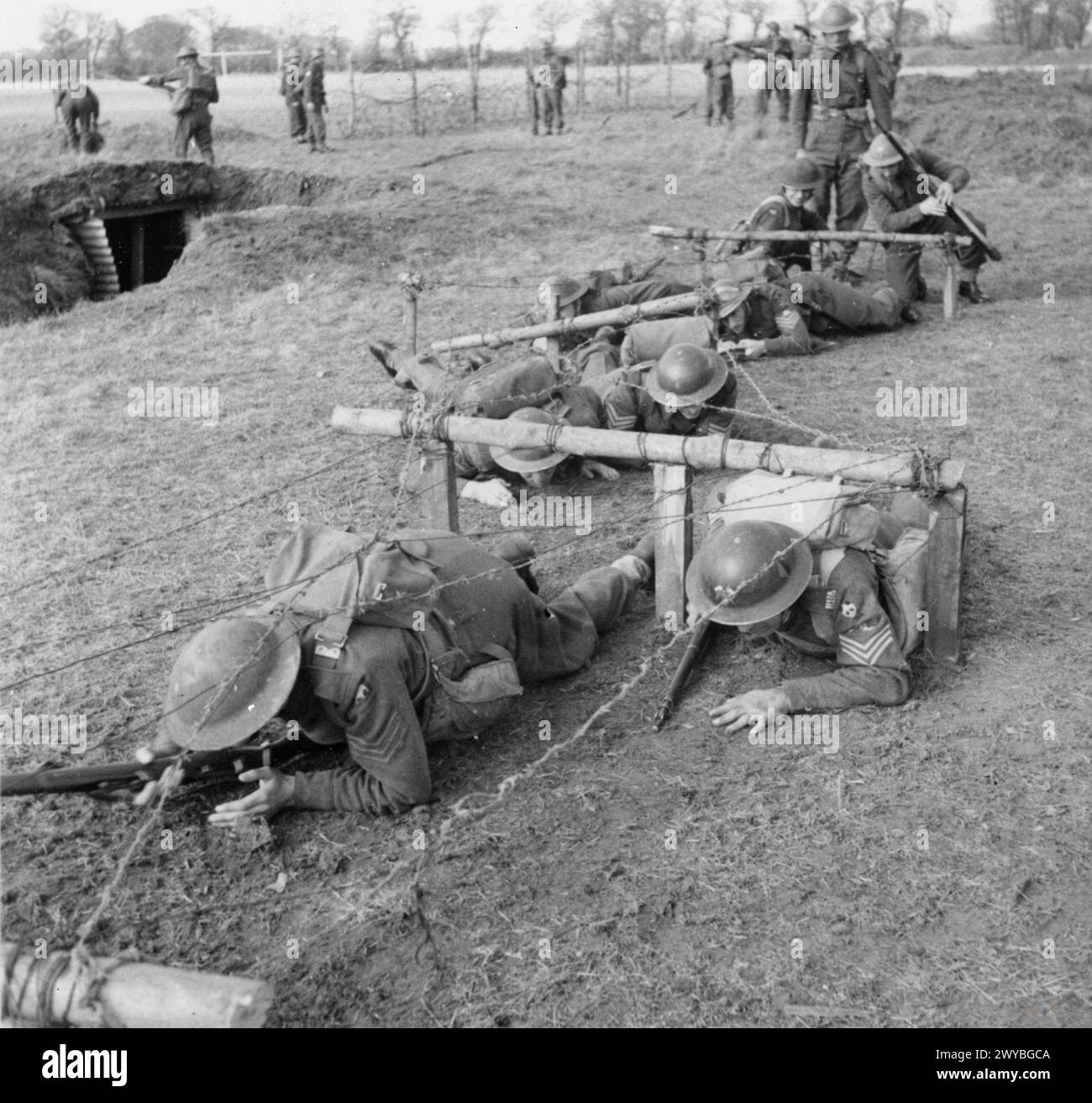 British Army infantry crawl under barbed-wire obstacles during battle ...