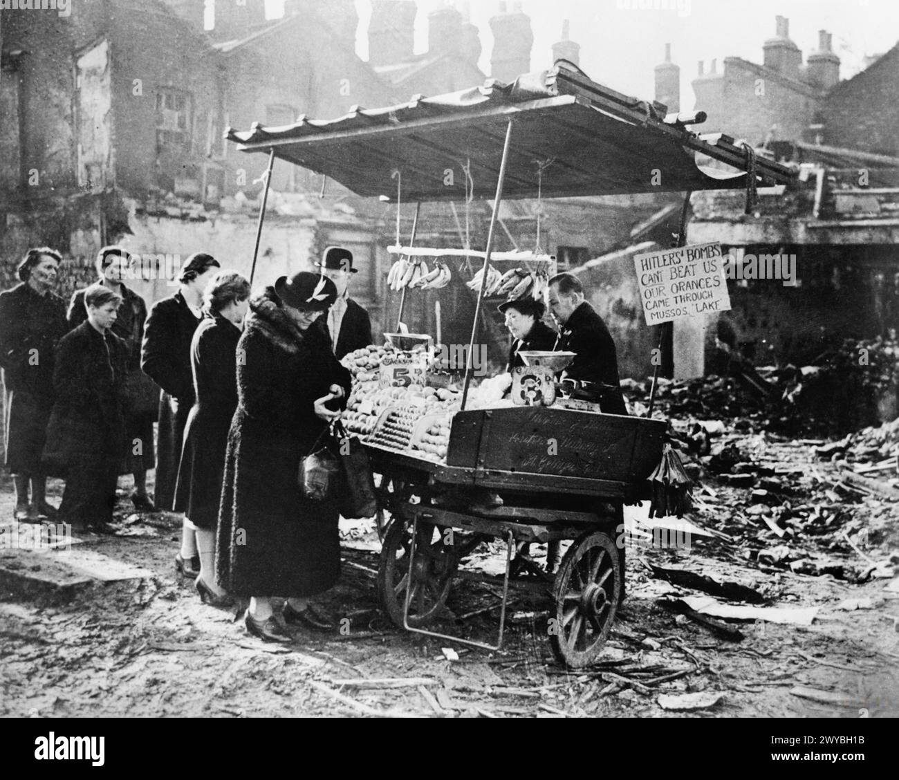 A motivational sign reflecting civilian resilience is posted behind a ...